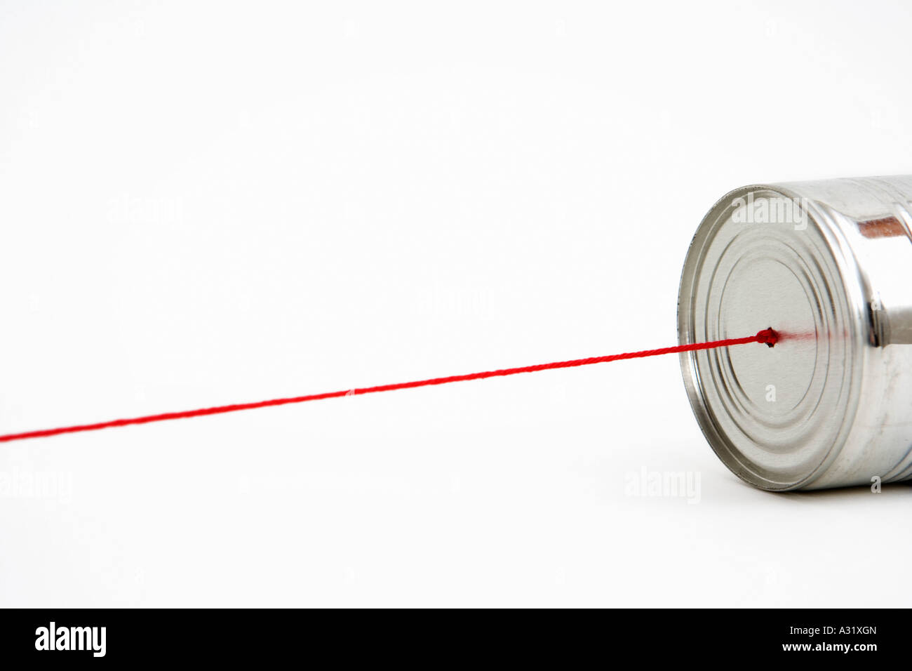 Red string attached to tin can Stock Photo - Alamy