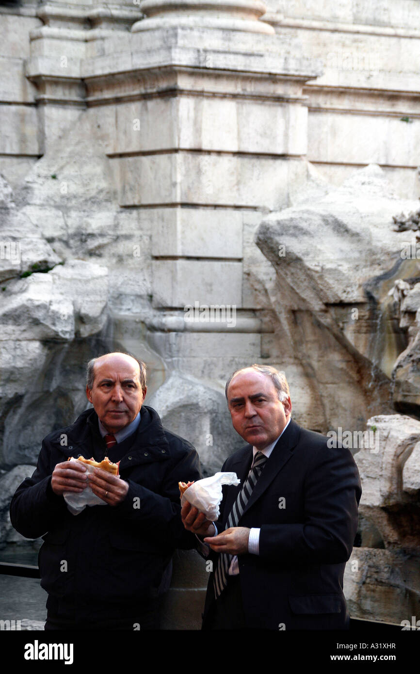 Italian men lunching by the Trevi Fountain in the Piazza di Trevi Rome ...