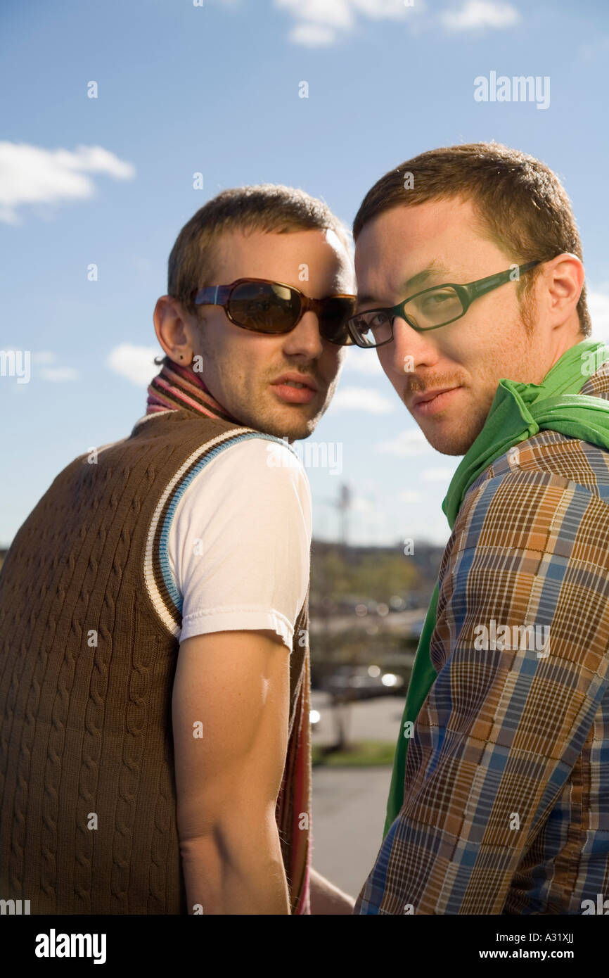 Two men turning to look at camera Stock Photo - Alamy