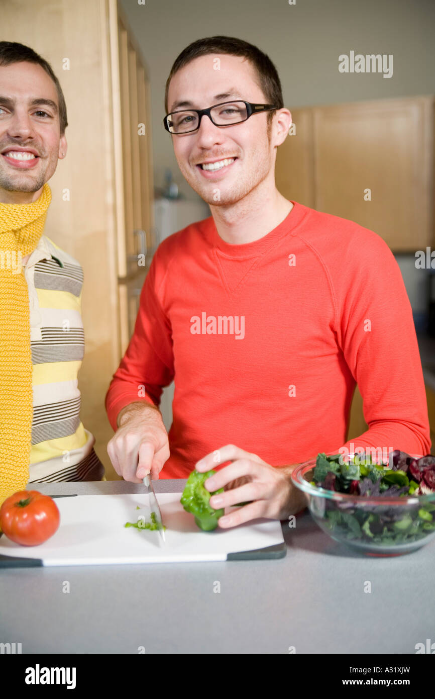 Two men preparing food in the kitchen Stock Photo - Alamy