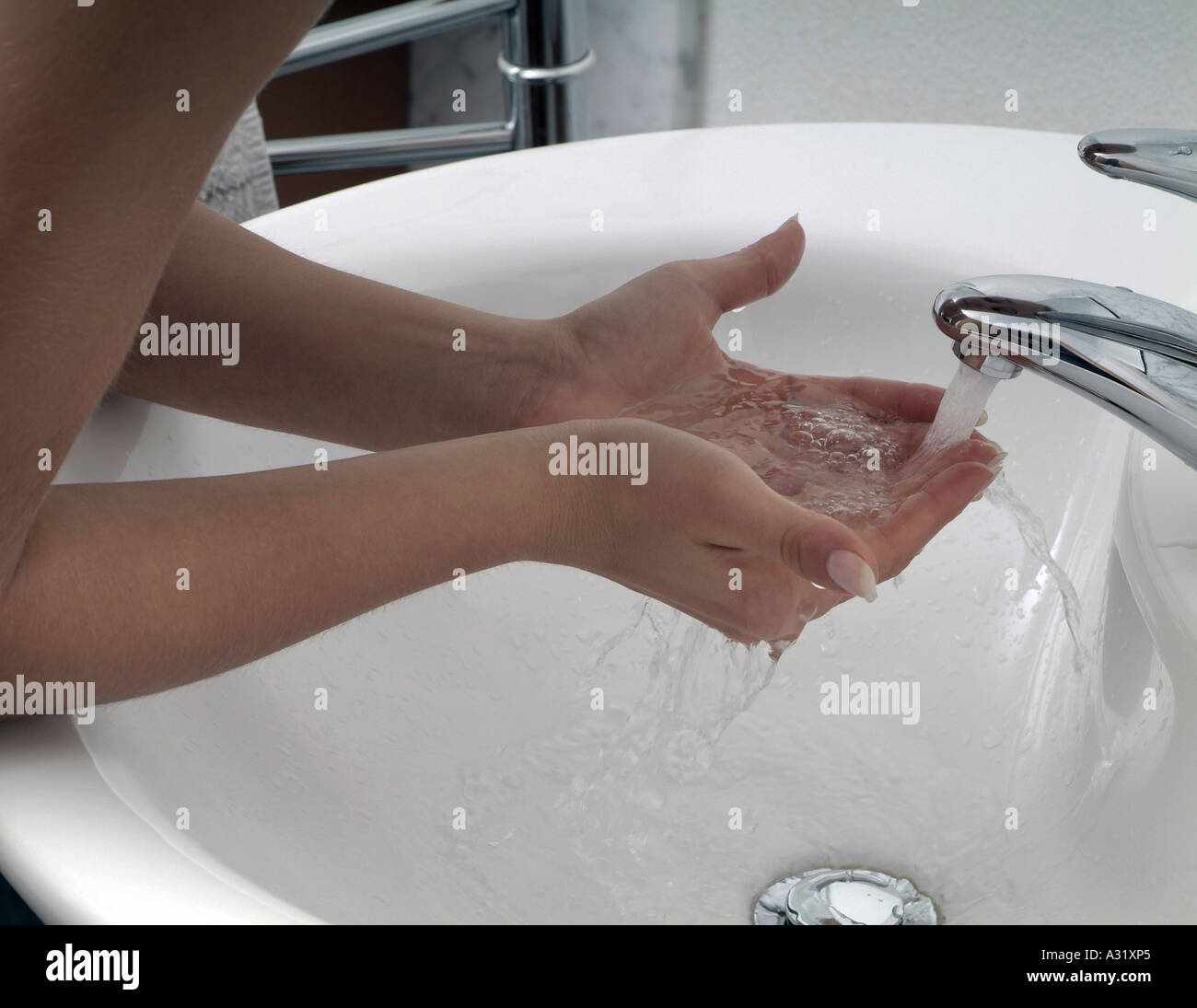 Water running through tap into cupped hands side view Stock Photo - Alamy