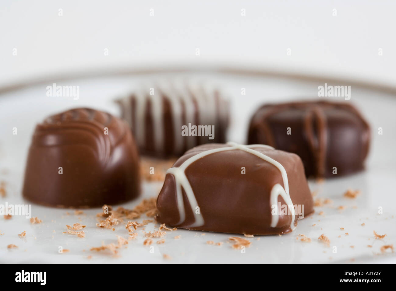 Four chocolates on a plate Stock Photo - Alamy