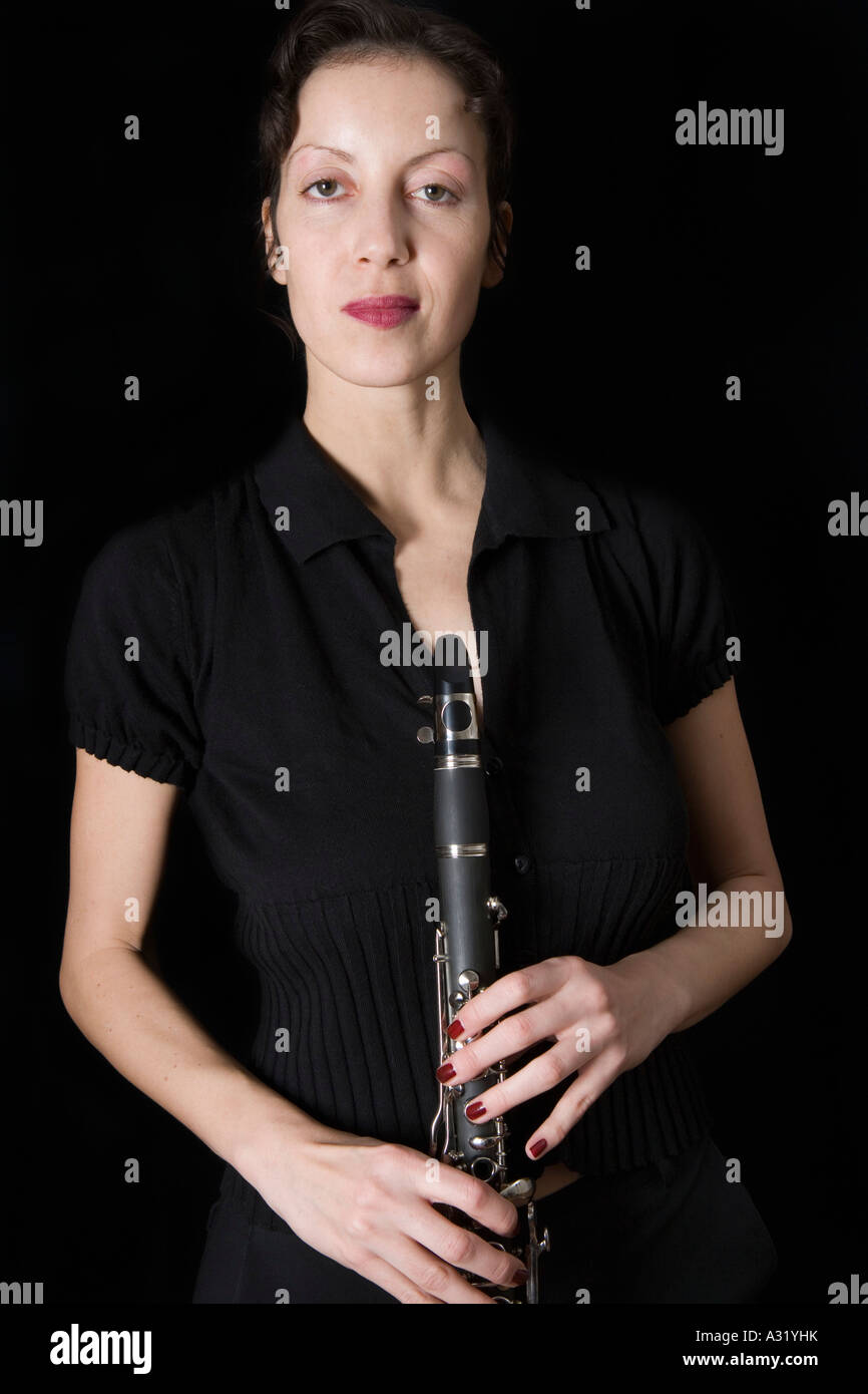 Woman holding a clarinet Stock Photo - Alamy