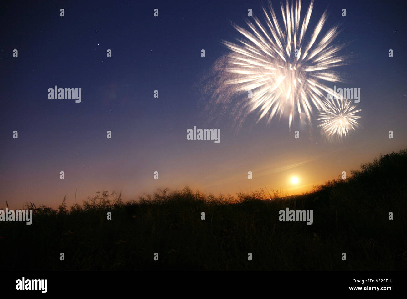 fireworks and the moon Stock Photo - Alamy
