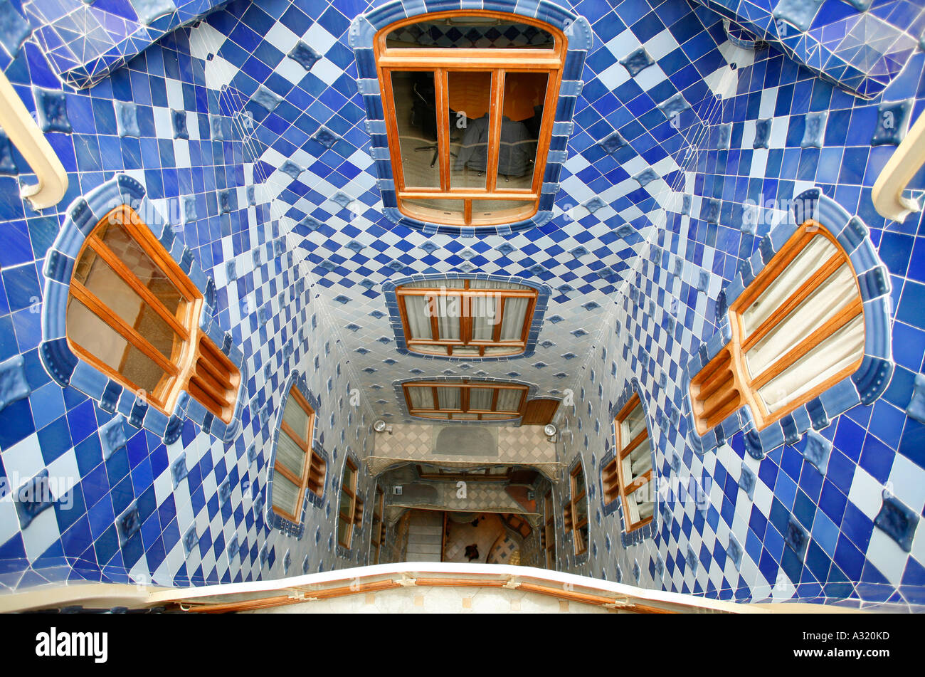 View down central stairwell of Casa Batllo showing tiles and windows ...