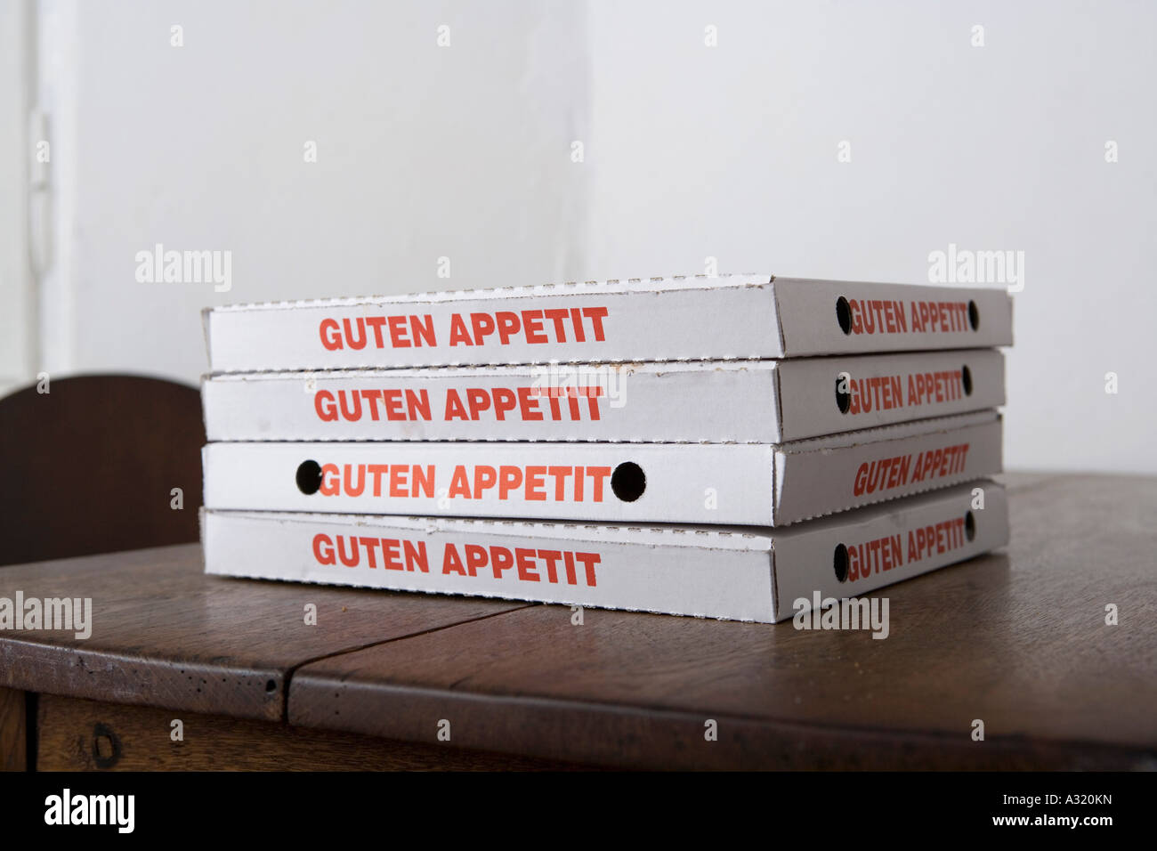 Stacked pizza boxes on table Stock Photo - Alamy