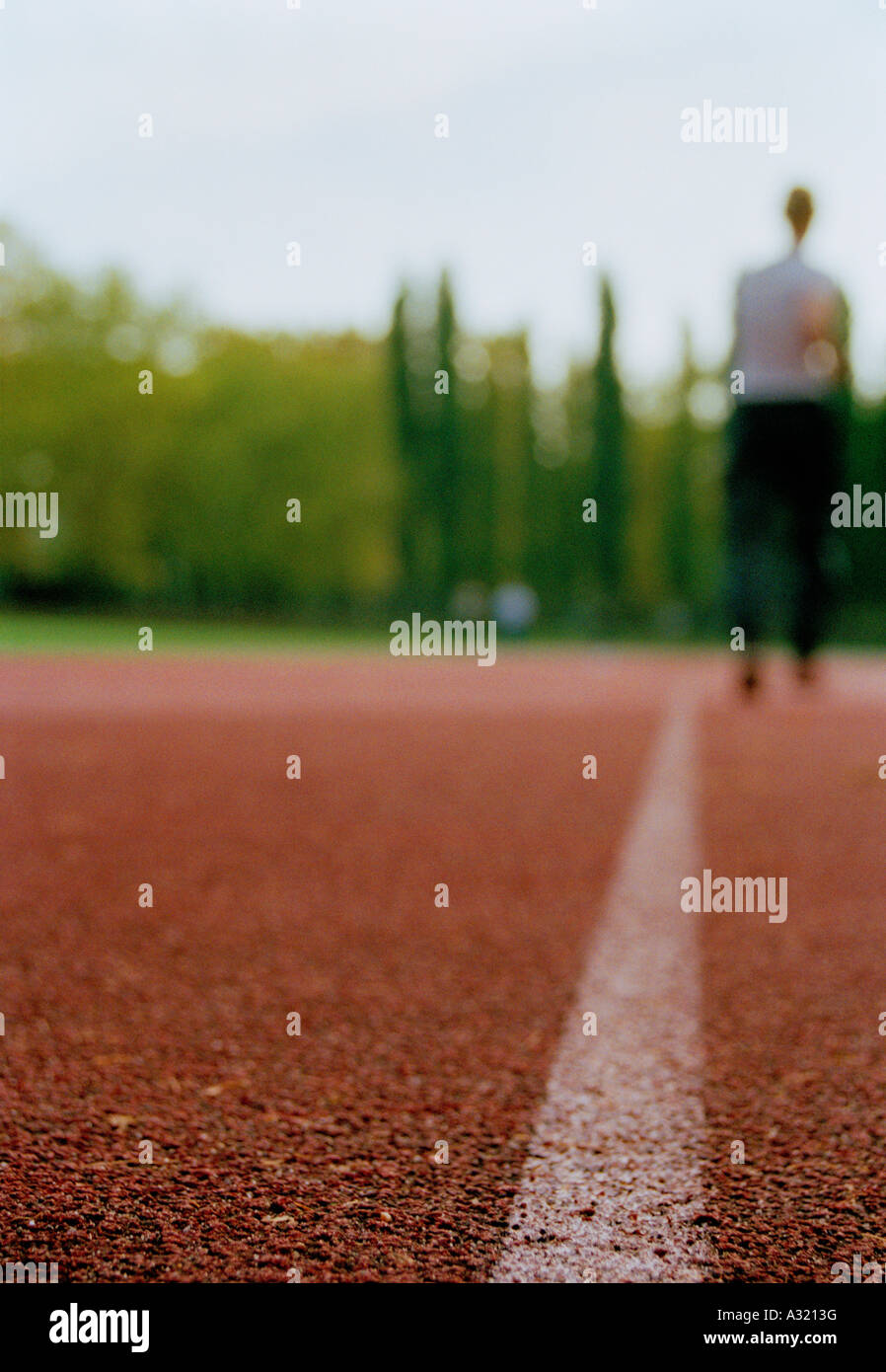 Man standing on running track Stock Photo - Alamy