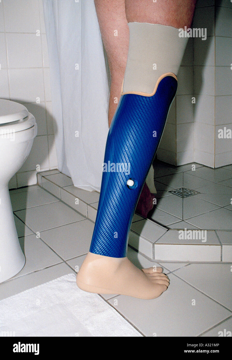 Low section of man getting into shower with prosthetic leg Stock Photo ...