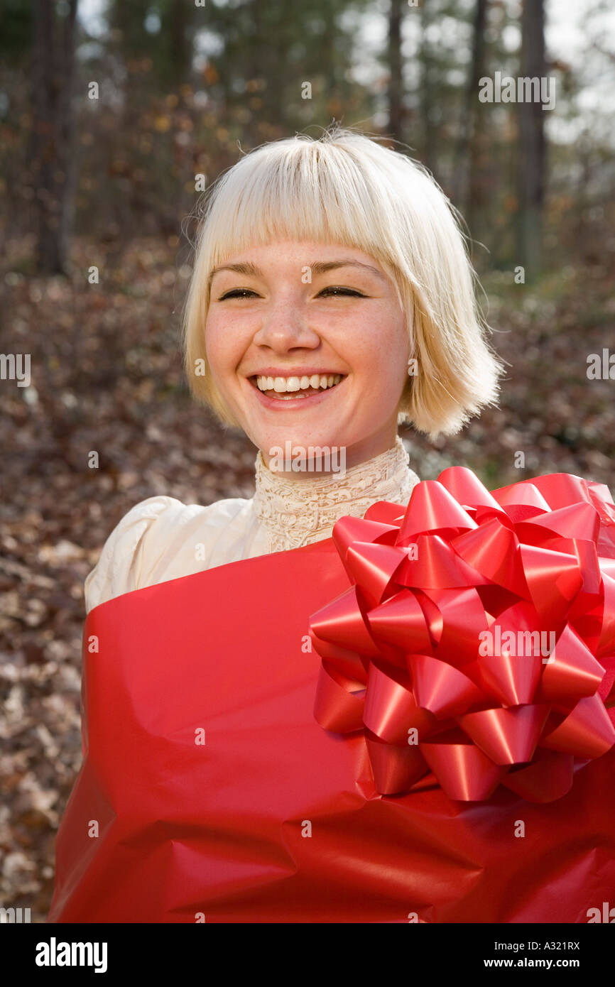 Young woman wrapped in wrapping paper Stock Photo - Alamy