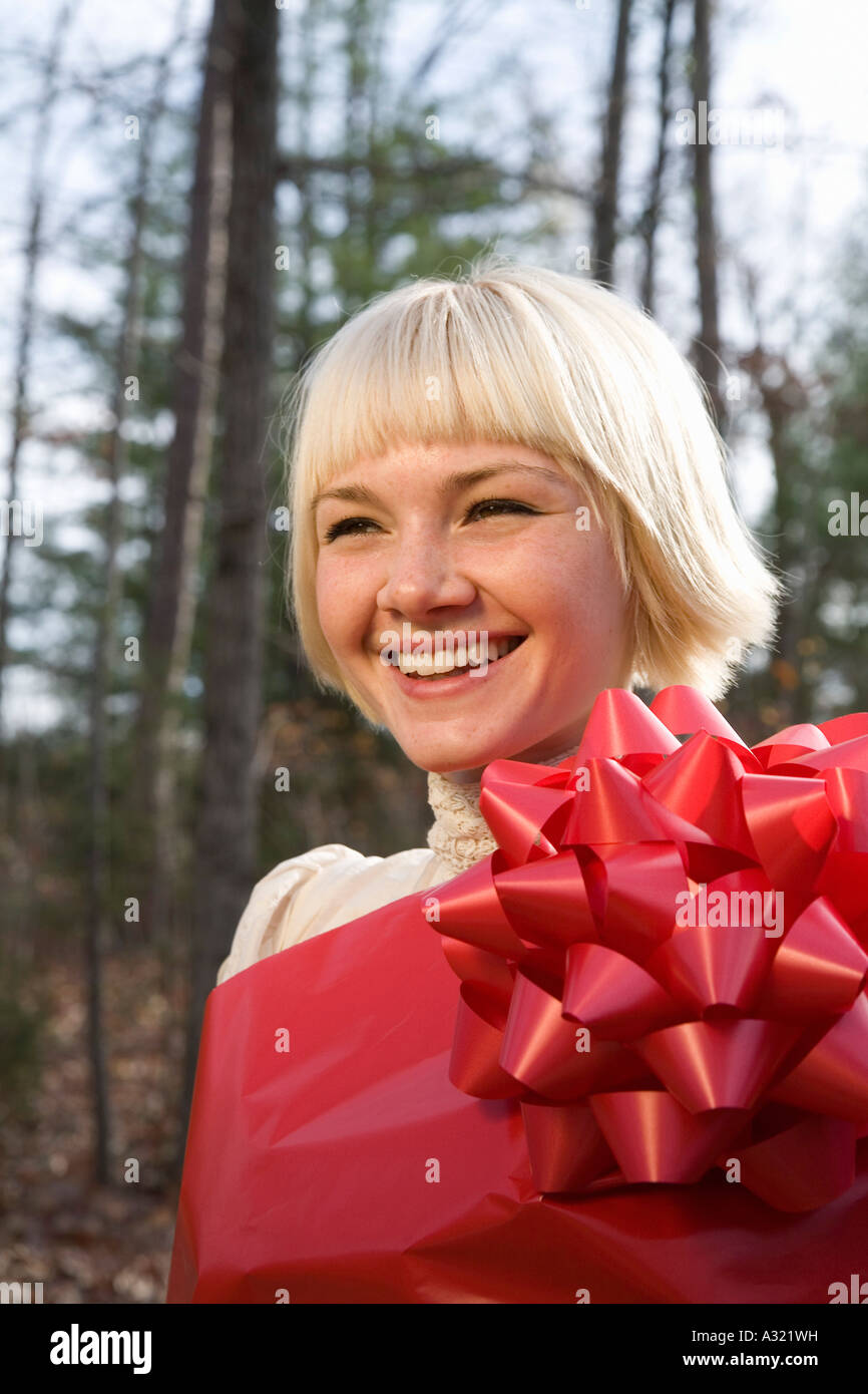 Young woman wrapped in wrapping paper Stock Photo - Alamy