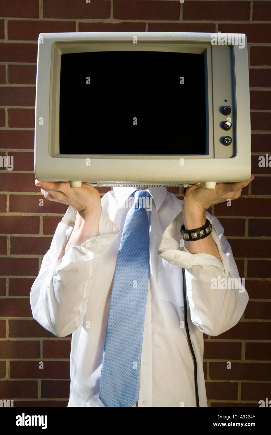 Man holding a television in front of his face Stock Photo - Alamy