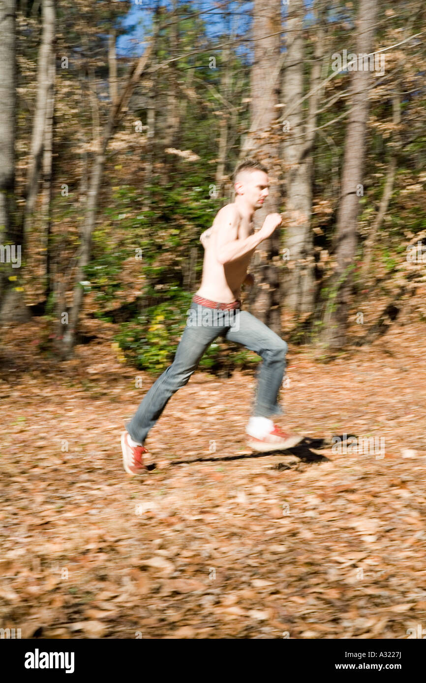 Man running through the woods Stock Photo - Alamy
