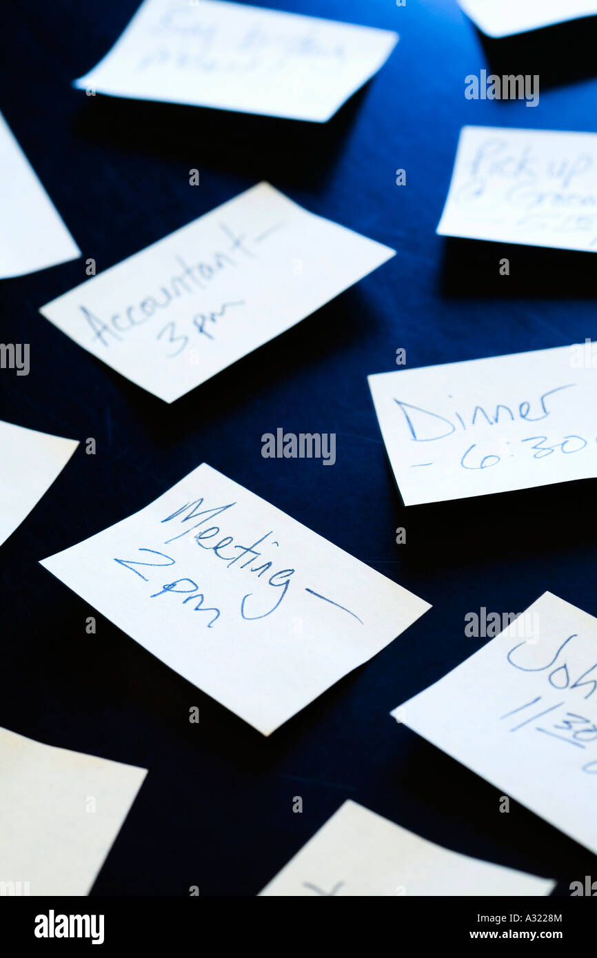 Adhesive notes with handwritten reminders stuck on a desk Stock Photo ...