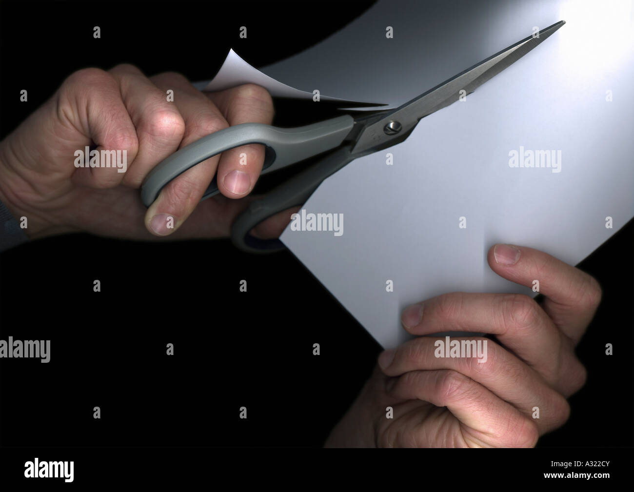 Man cutting paper with scissors Stock Photo - Alamy