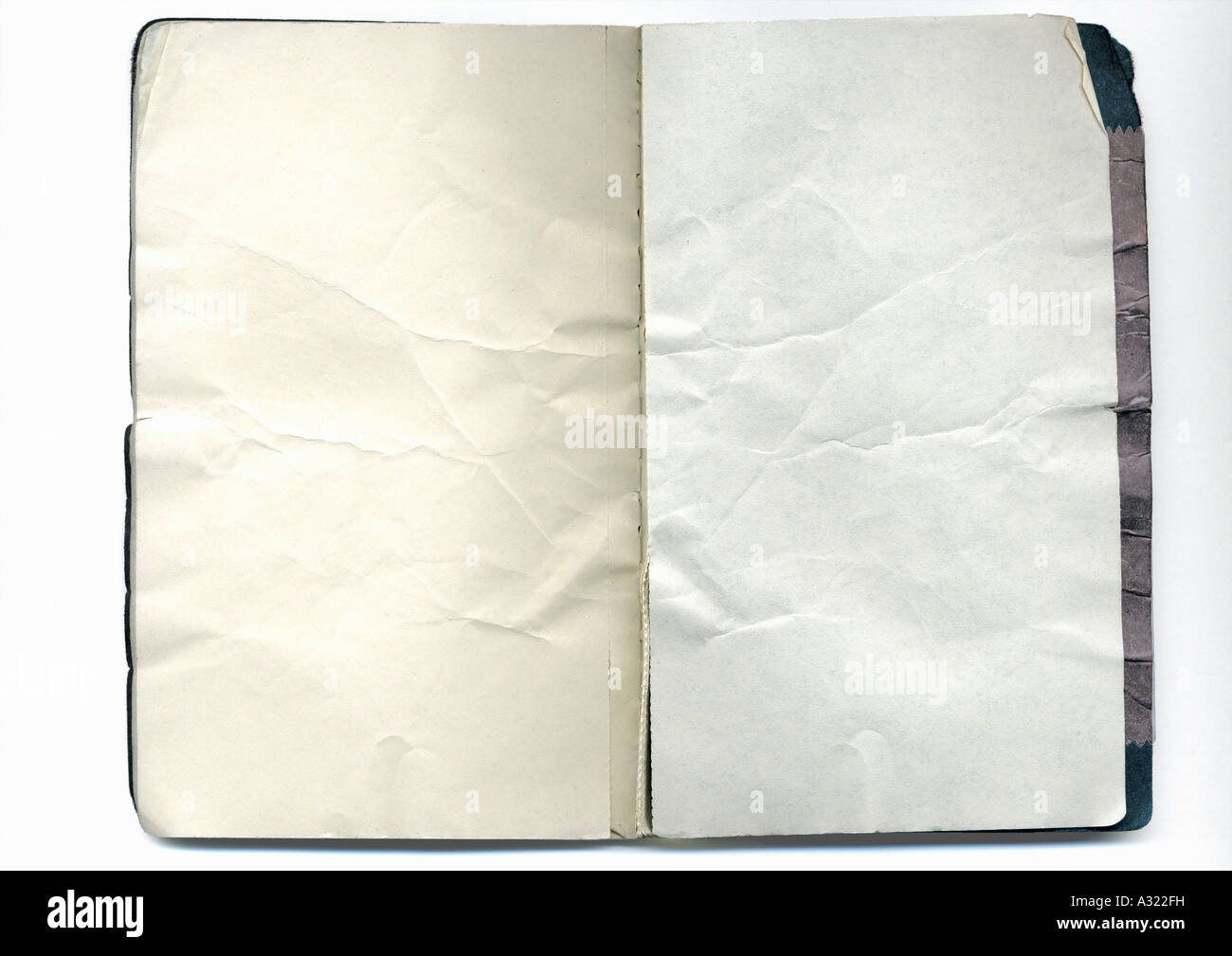 Open notebook with crumpled pages Stock Photo - Alamy