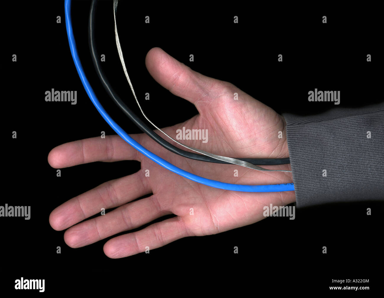 Man with cables and wires extending from his sleeve Stock Photo - Alamy