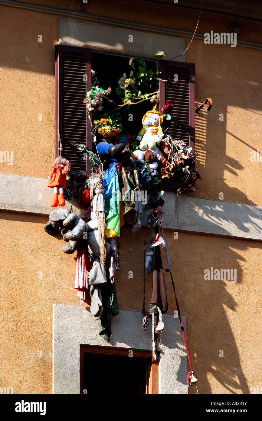 Surreal objects hanging from windows in the Trastevere area of Rome ...