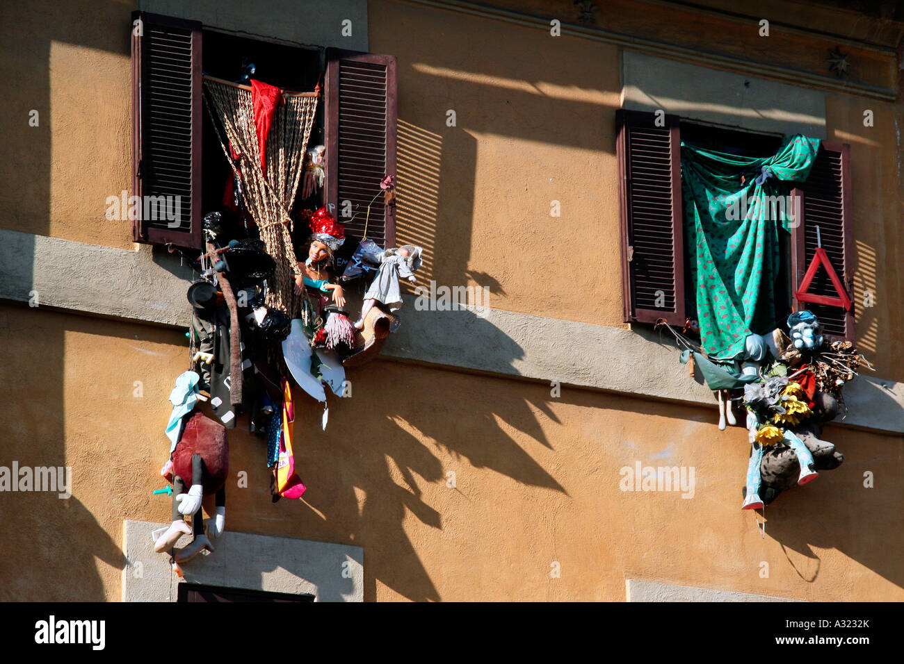 Surreal objects hanging from windows in the Trastevere area of Rome ...