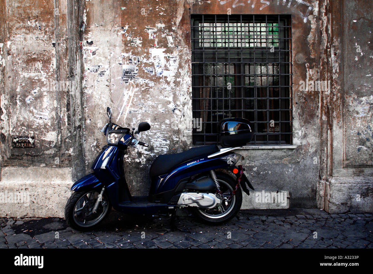 Motor scooter parked in front of house in the Trastavere area of Rome ...
