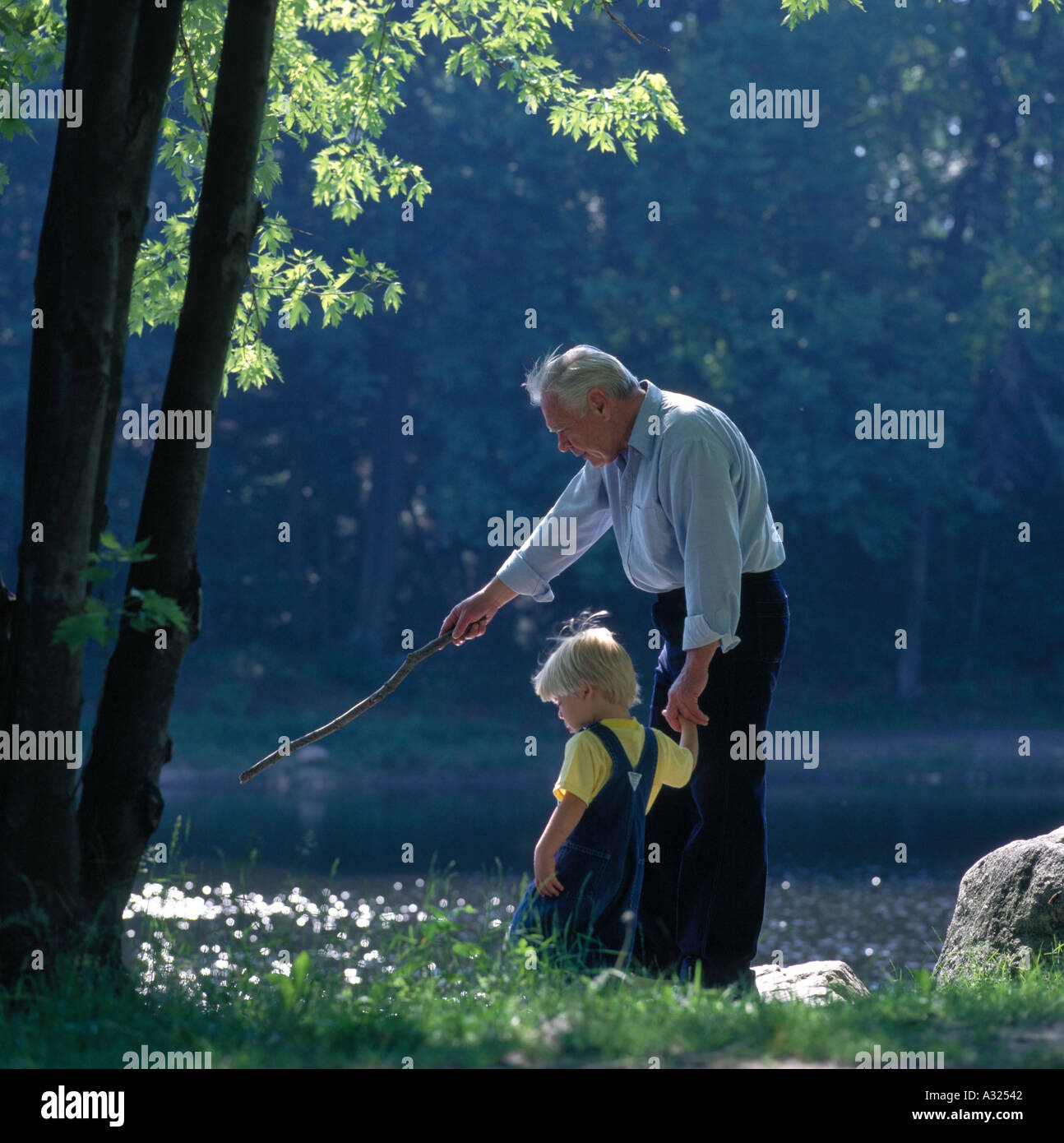 Grandfather holding grandsons hand hi-res stock photography and images ...