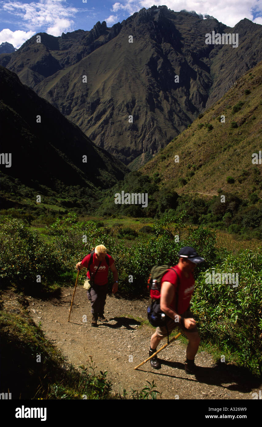 Vertical landscape with walkers on the Inca trail, climbing the Andean ...