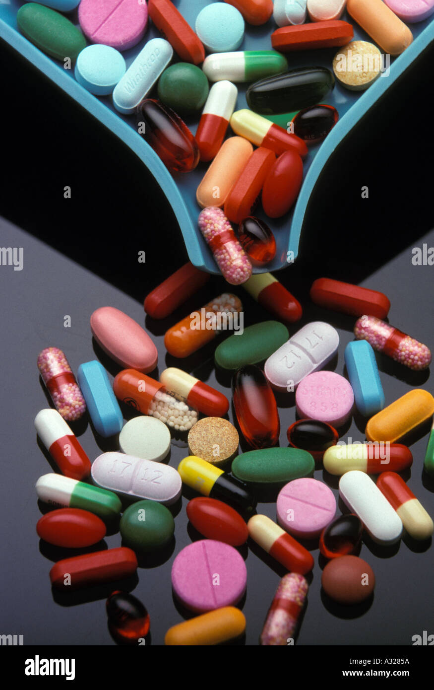 pharmacist counting tray with various pills capsules tablets gel caps ...