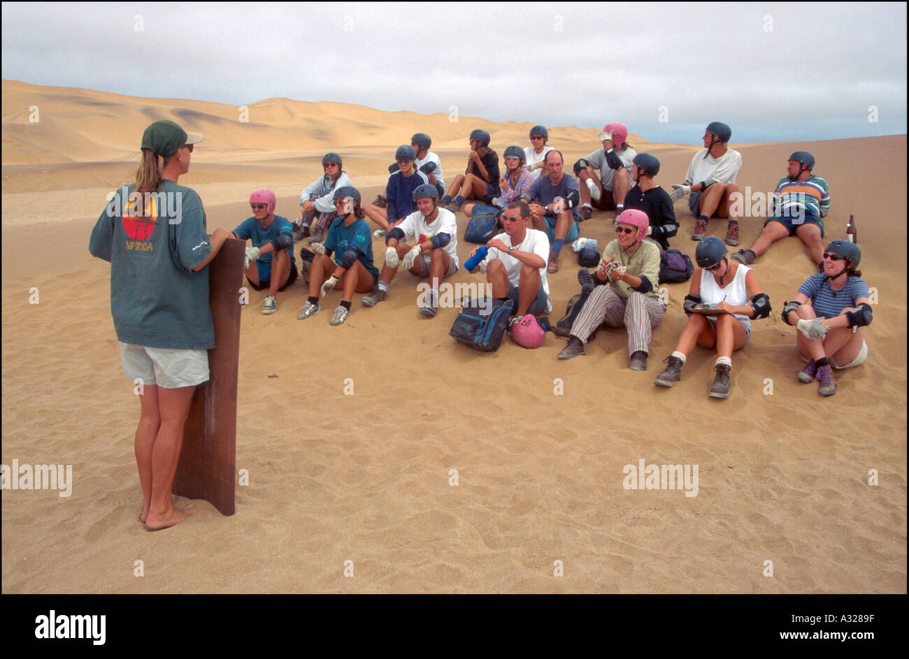 NAMIBIA Tourists sand surfing Stock Photo - Alamy