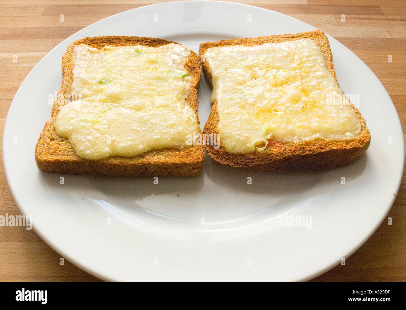 Cheese melt melted on wholemeal brown Toast bread on a plate grill ...
