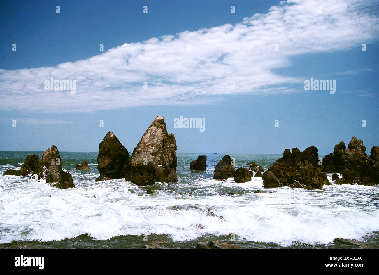 White Sea blue sky beach rocks at Bagha Beach Goa India Stock Photo - Alamy