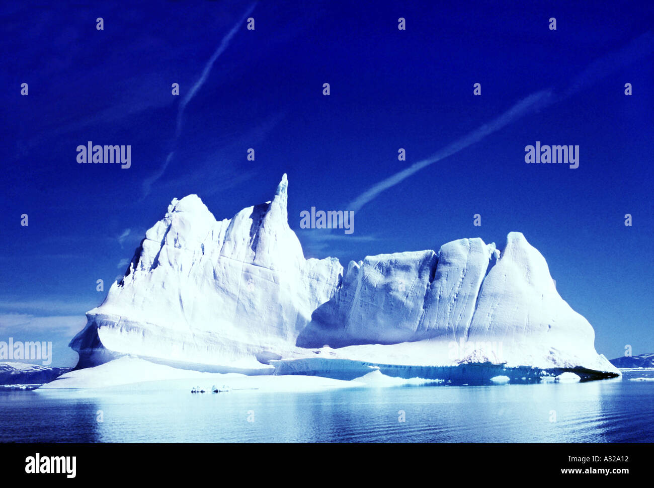 Seascape of pure white huge big giant Iceberg blue sky pure clean sea ...