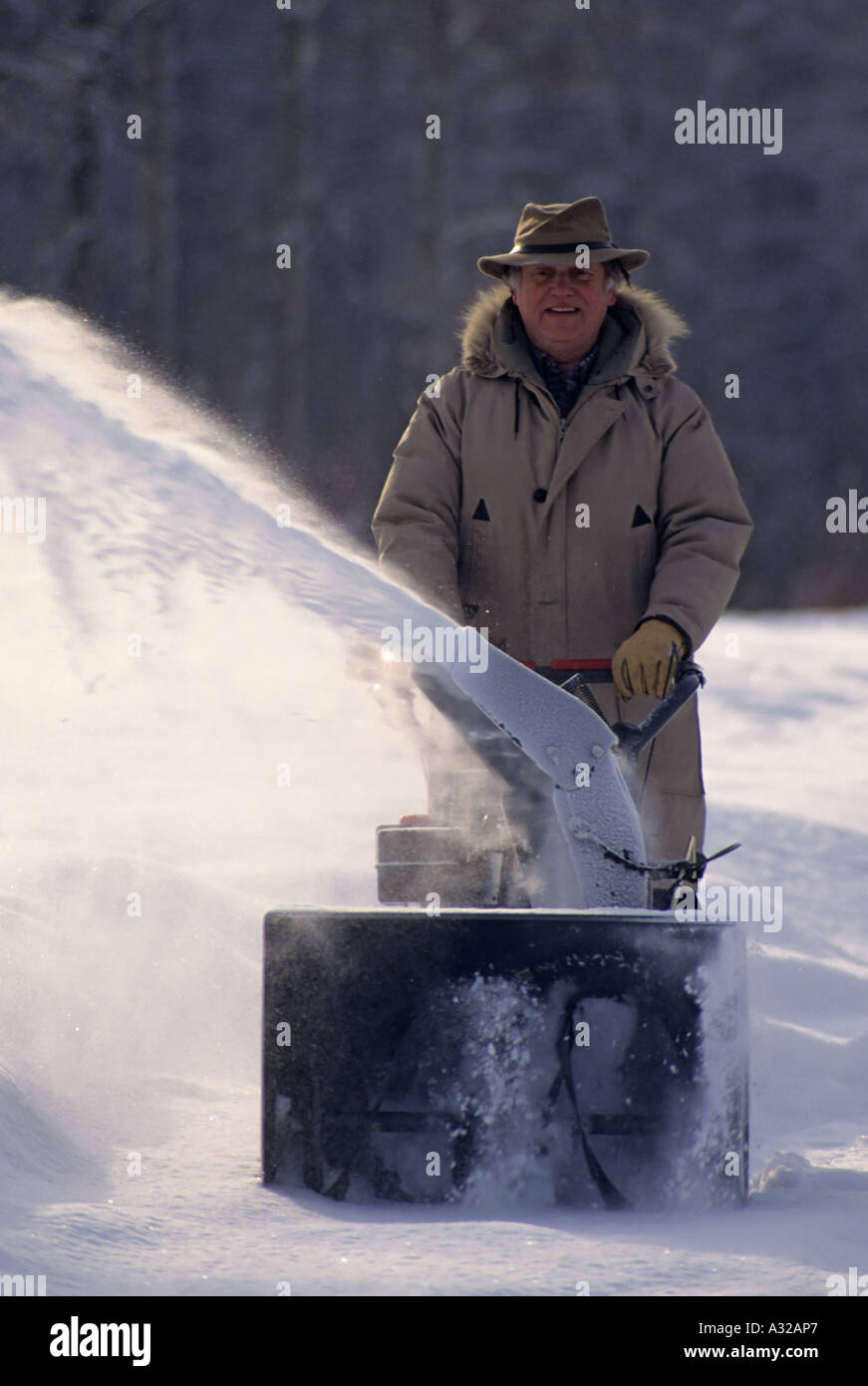 Man using snowblower Smithers British Columbia Stock Photo - Alamy