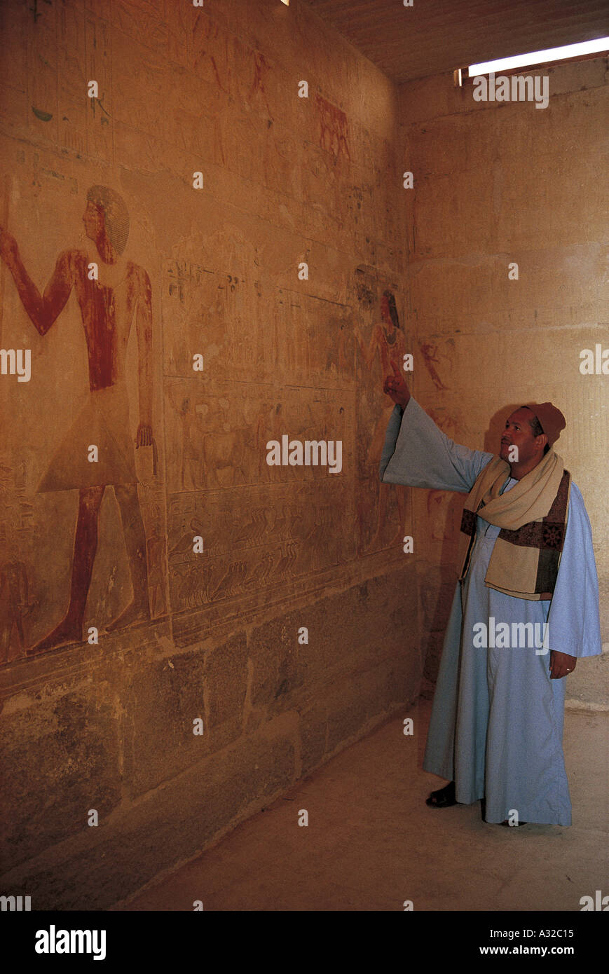 Tomb Saqqara with guardian pointing out a Pharaonic mural, Egypt Stock ...