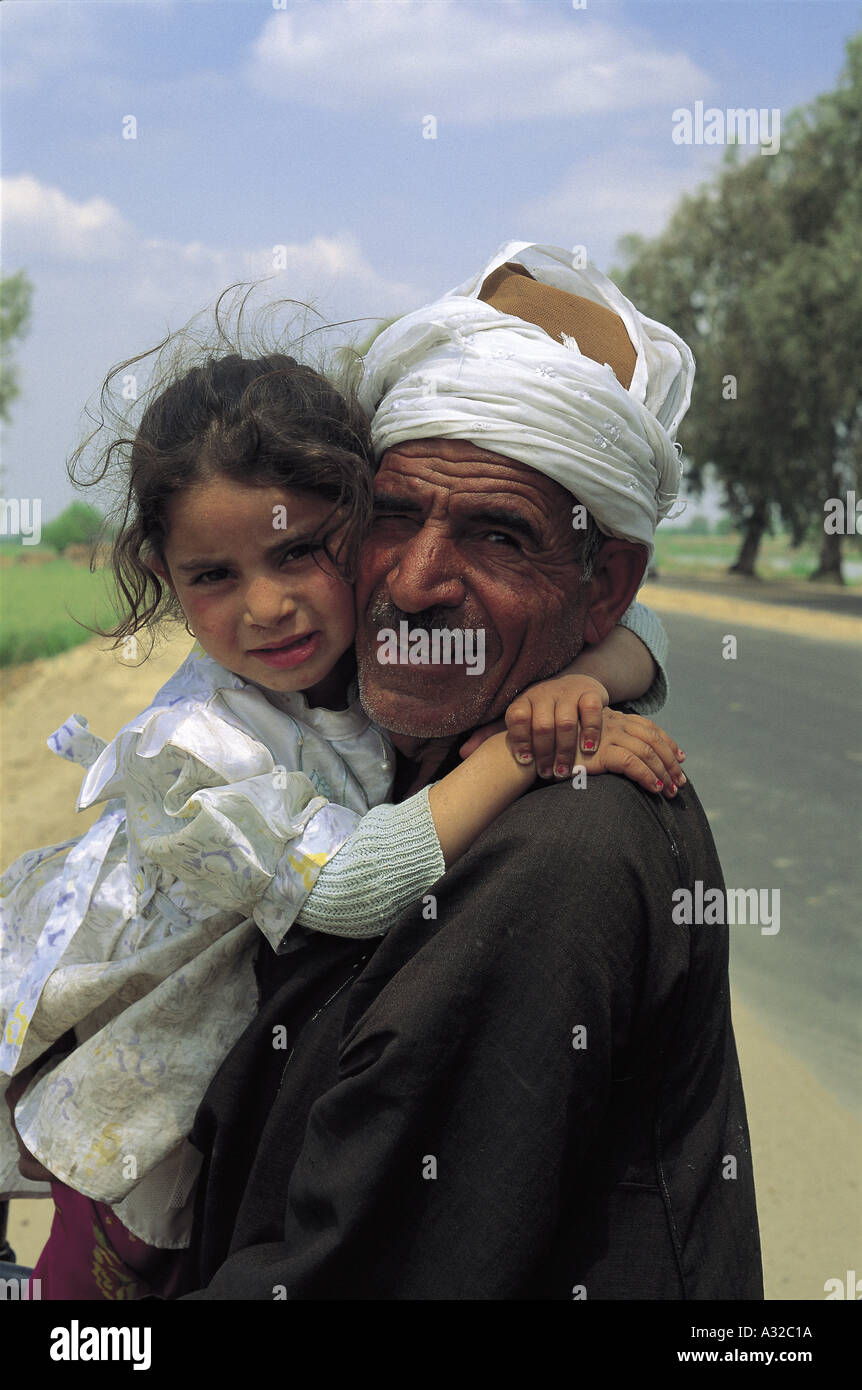 Young girl hugging her grandfather, a farmer in Middle Egypt Stock ...