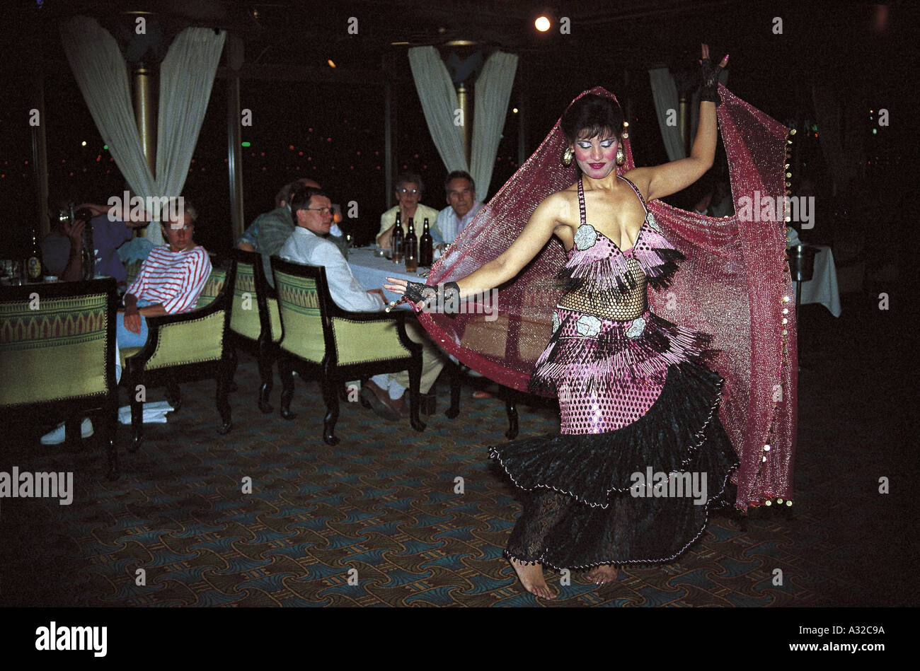 Belly-dancer entertaining tourists in a restaurant in Cairo, Egypt ...