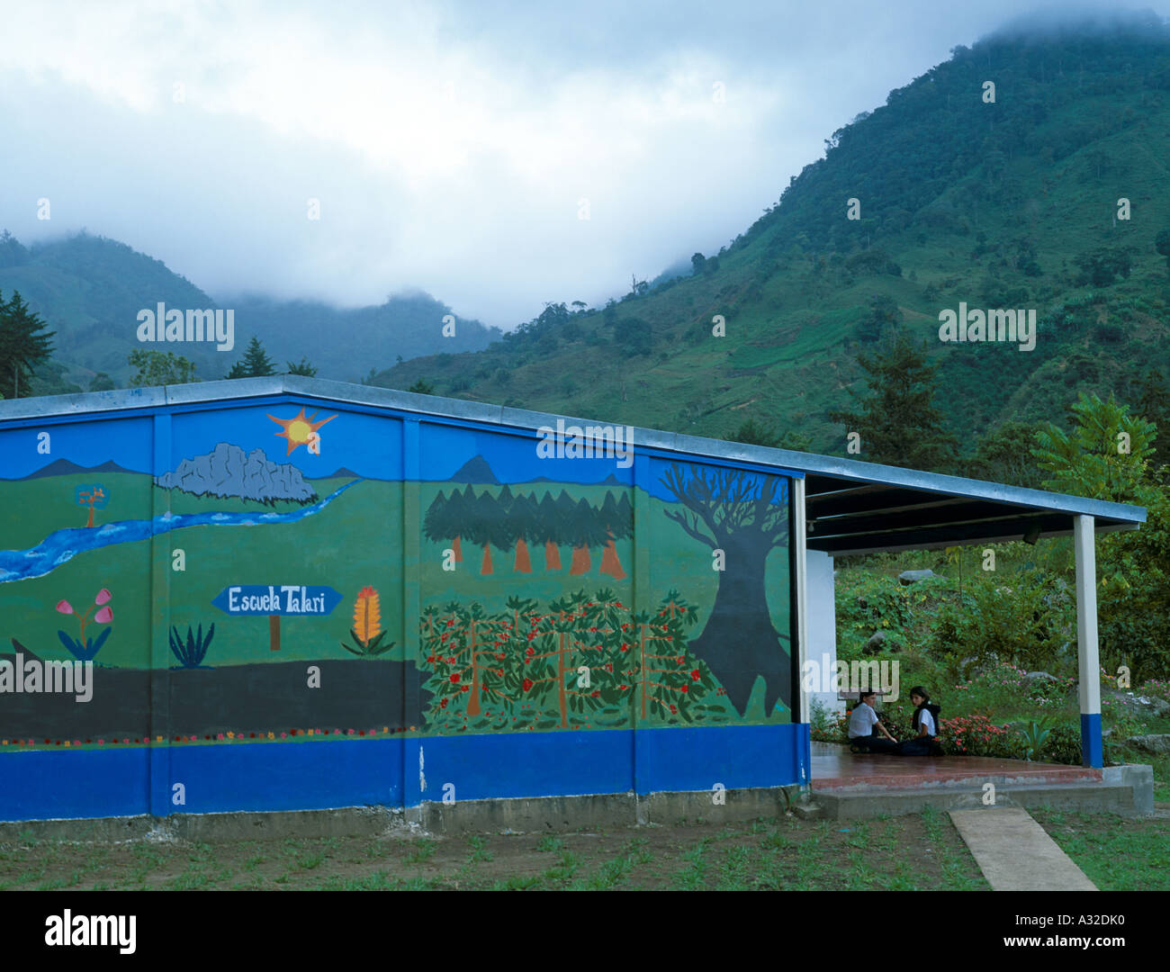 Two girls on steps of school with ecological mural Chirripo National ...
