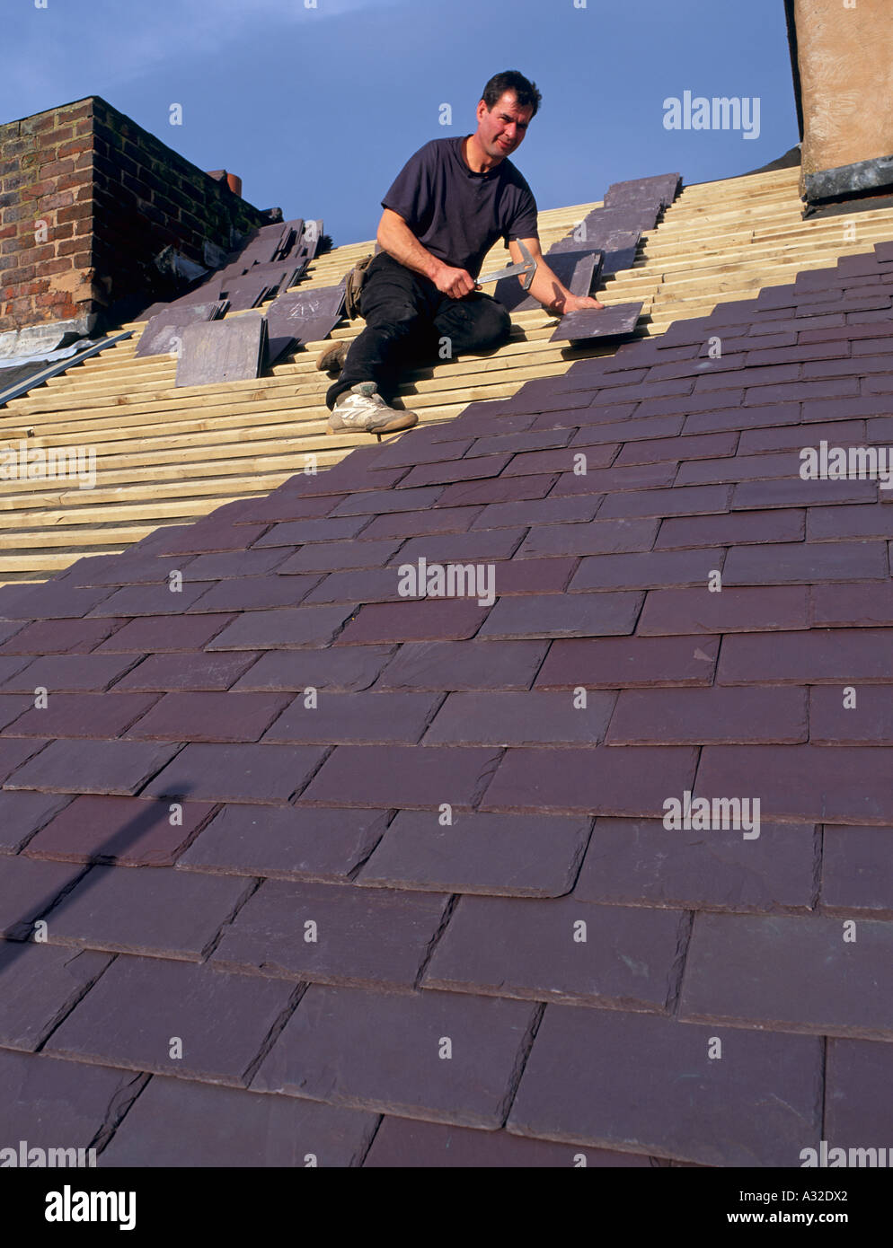 Roofer laying slate on roof Denbigh North Wales United Kingdom UK Stock ...