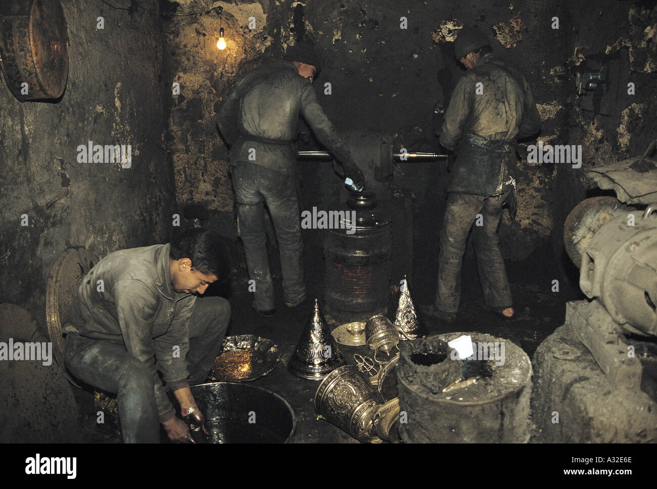Workers casting silverware using traditional methods, scene in the ...