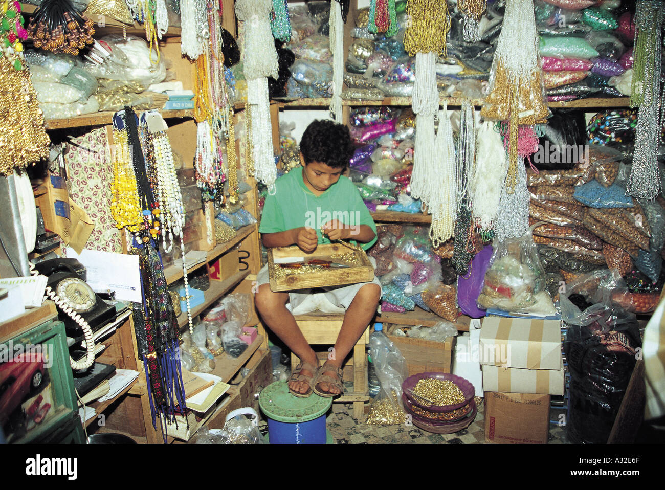 Young boy stringing beads in his father';s shop in Fez, Morocco, Child ...
