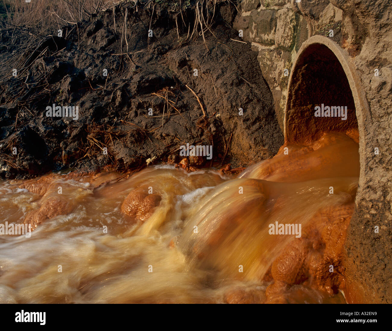 Chemical outflow pipe flowing into watercourse Merseyside Stock Photo ...