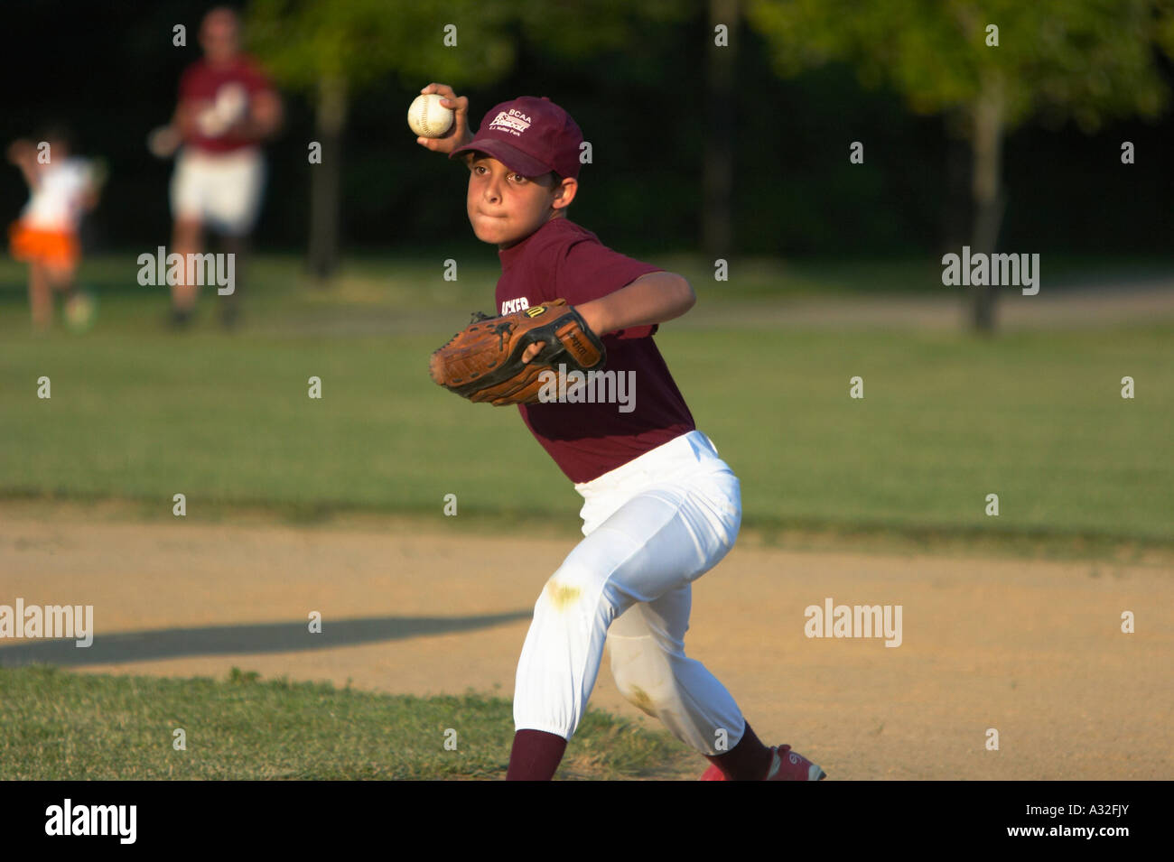 A boy playing second base throwing a baseball Stock Photo - Alamy
