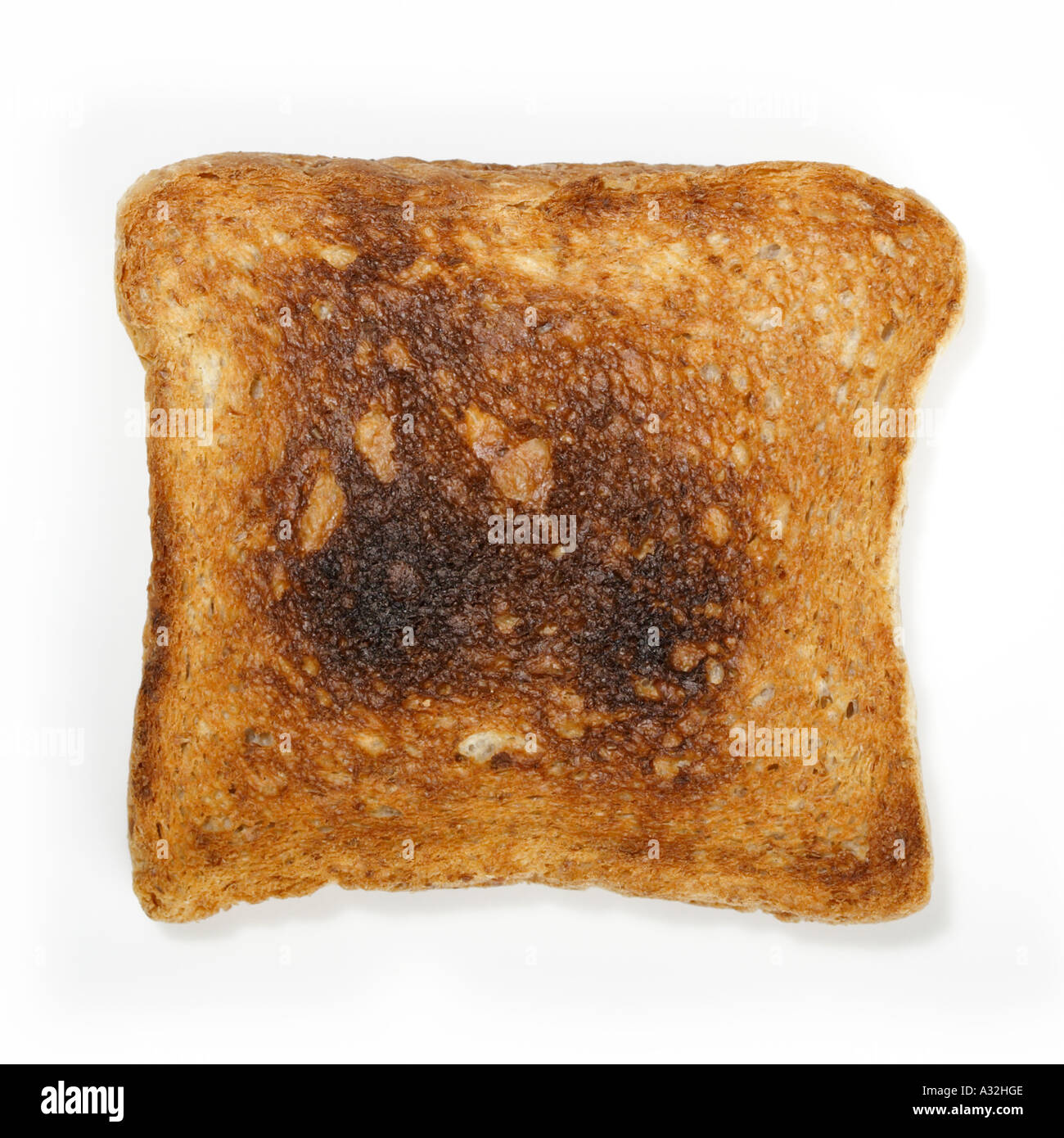 Slice of burnt toast on white background Stock Photo - Alamy