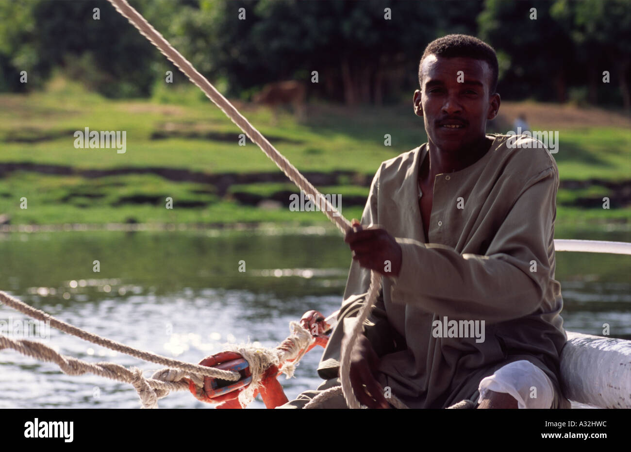 Horizontal portrait of Egyptian felucca sailor on board his boat on a ...