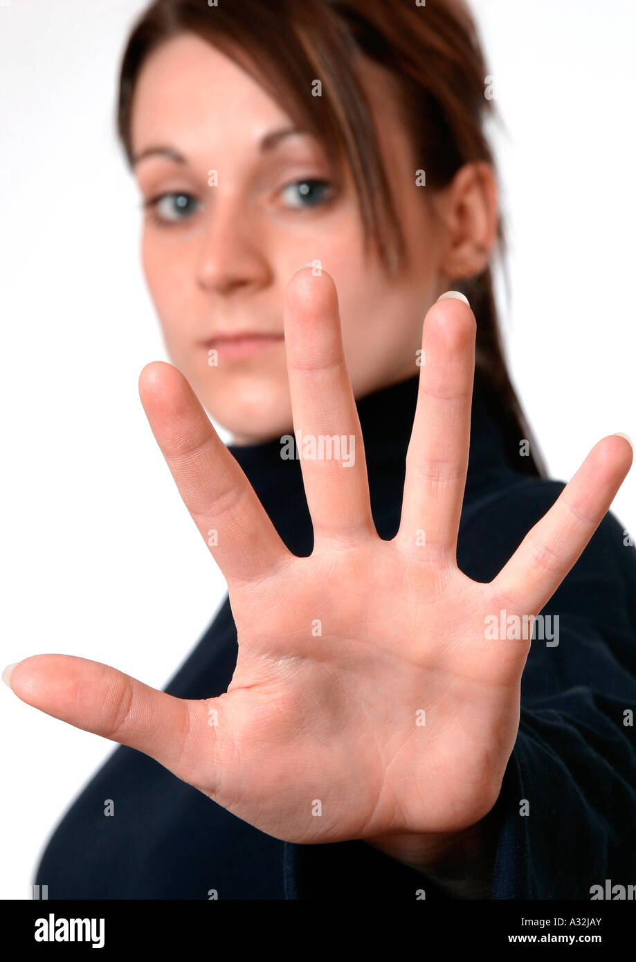 young woman with her hand raised Stock Photo - Alamy