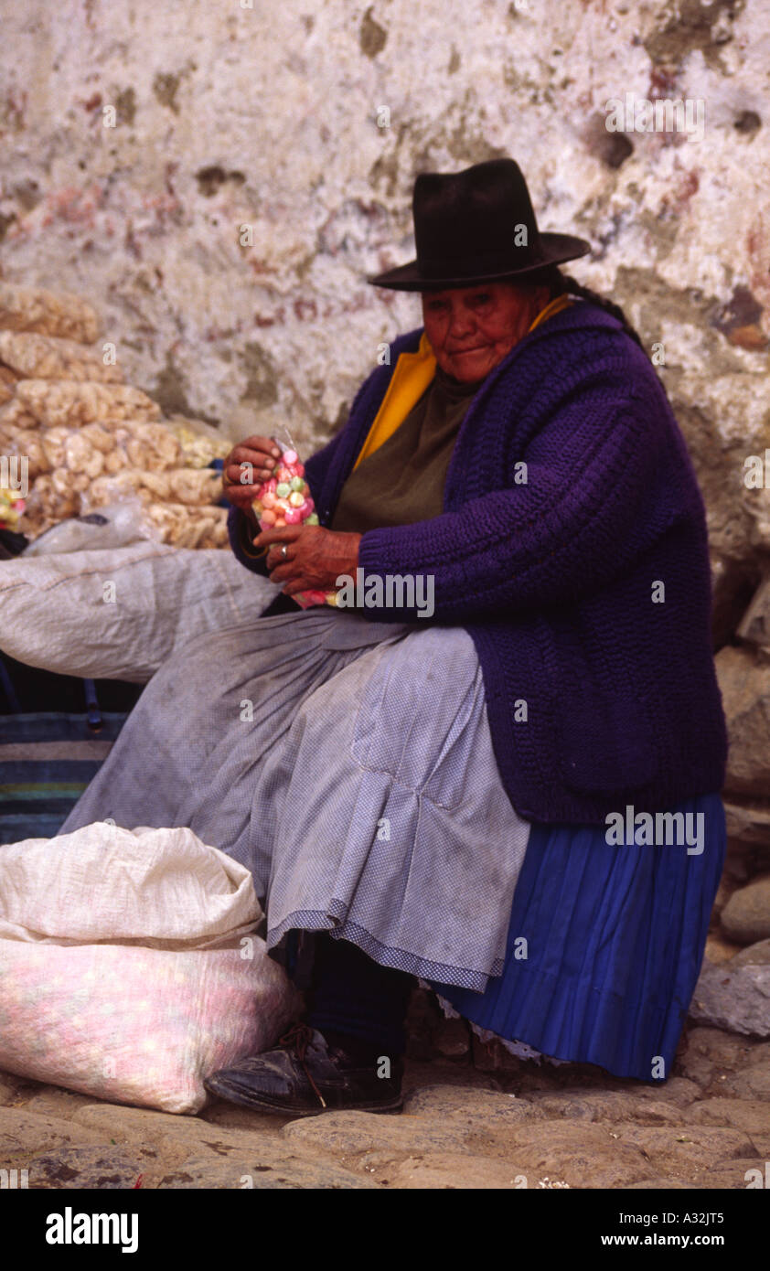 Peruvian market vendor wraps sweets for sale at her stall in ...