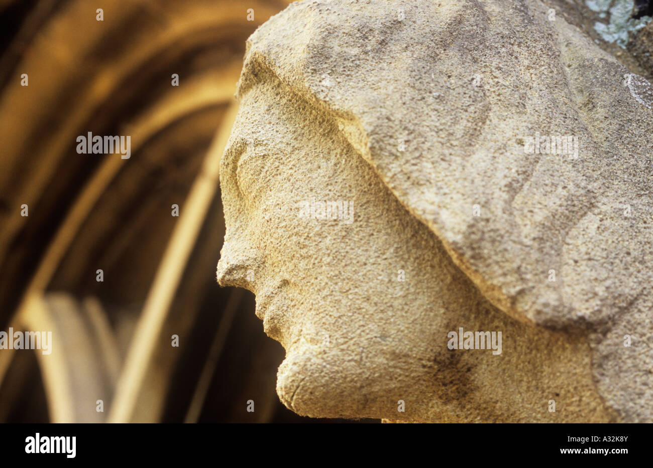 Close up of worn carved stone corbel of womans head with Victorian ...