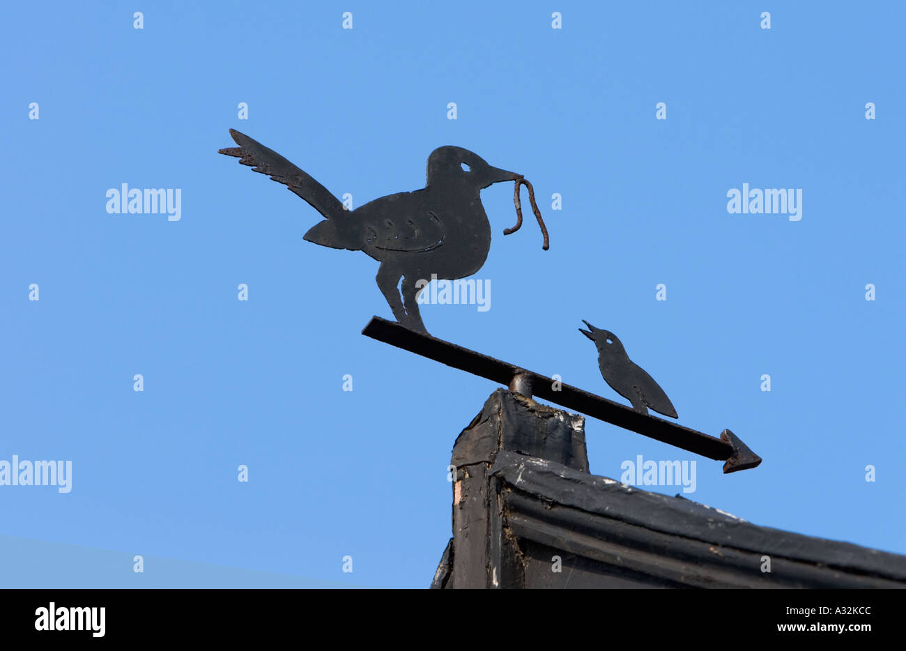 Bird weather vane, wind direction indicator on corner of roof, low ...