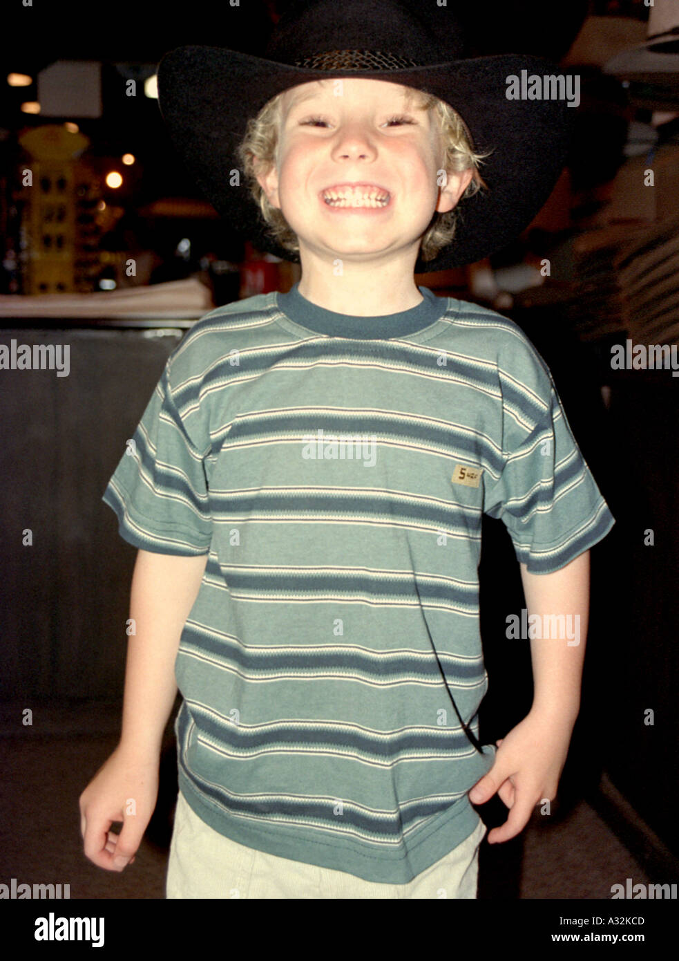 A BOY APPROX 9 YEARS OLD HAVING FUN TRYING ON HATS Stock Photo - Alamy