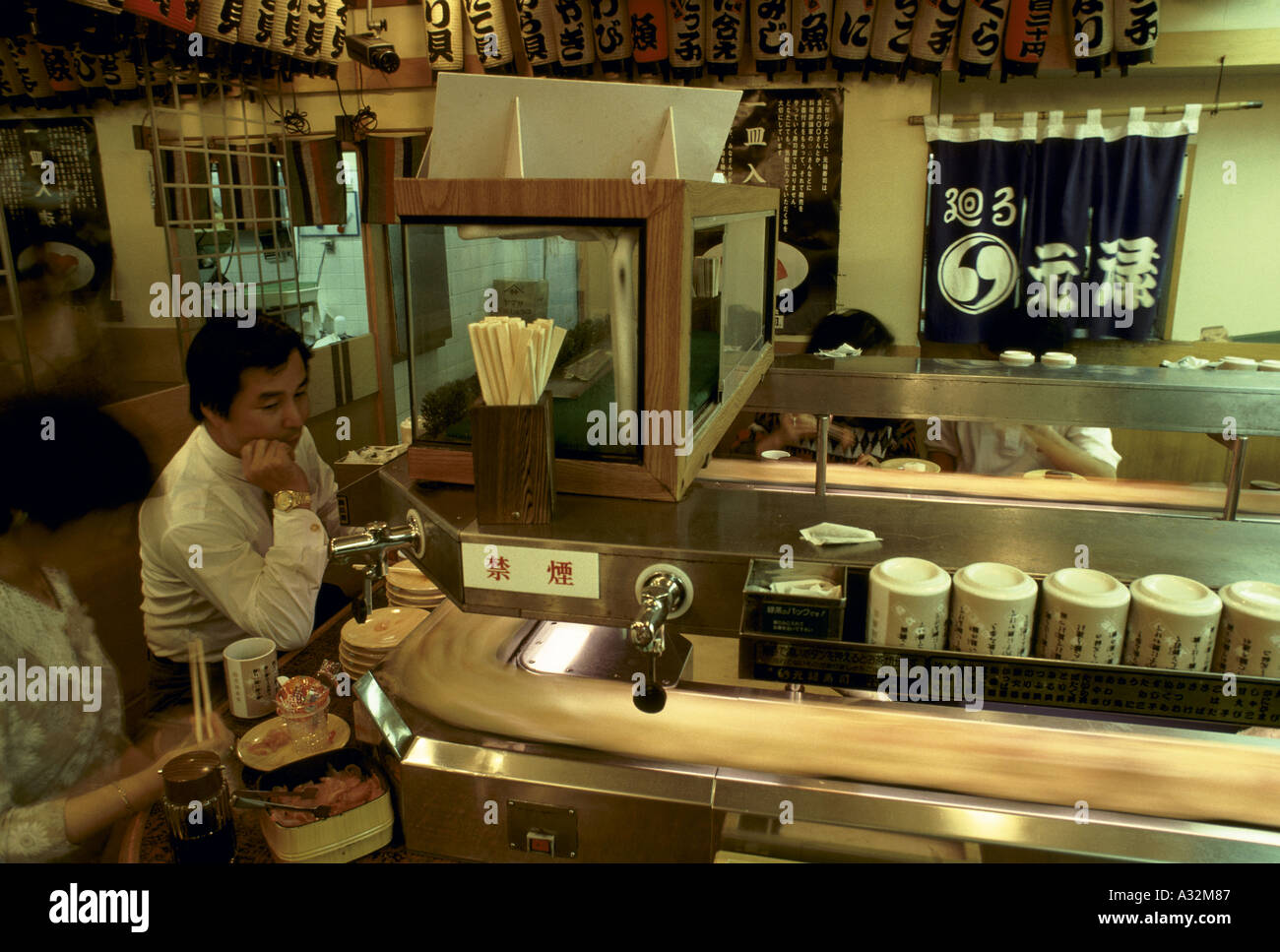 fast food in japan diners in a sushi cafe eating lunch Stock Photo - Alamy