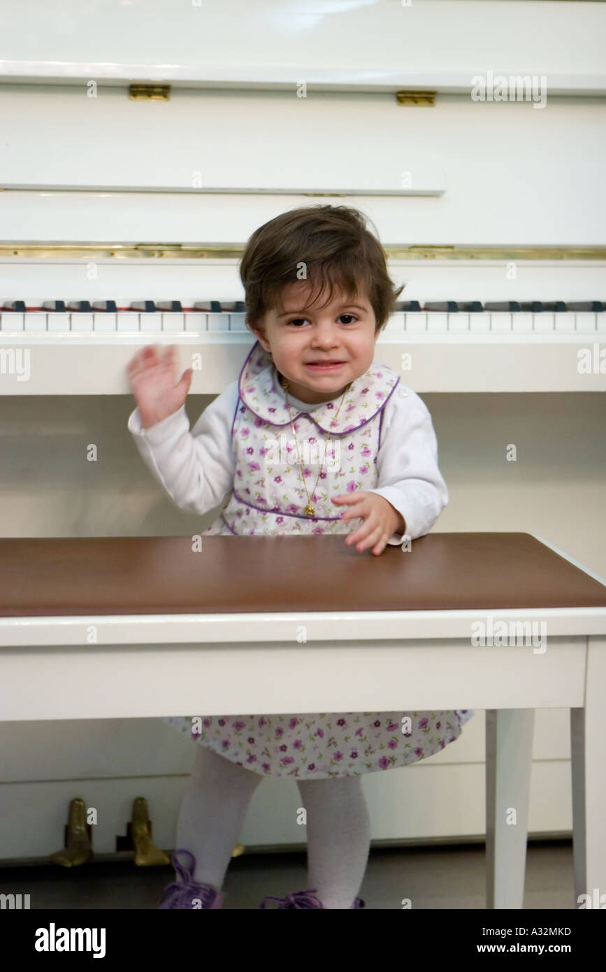 Cheerful baby girl waving her hand Stock Photo - Alamy
