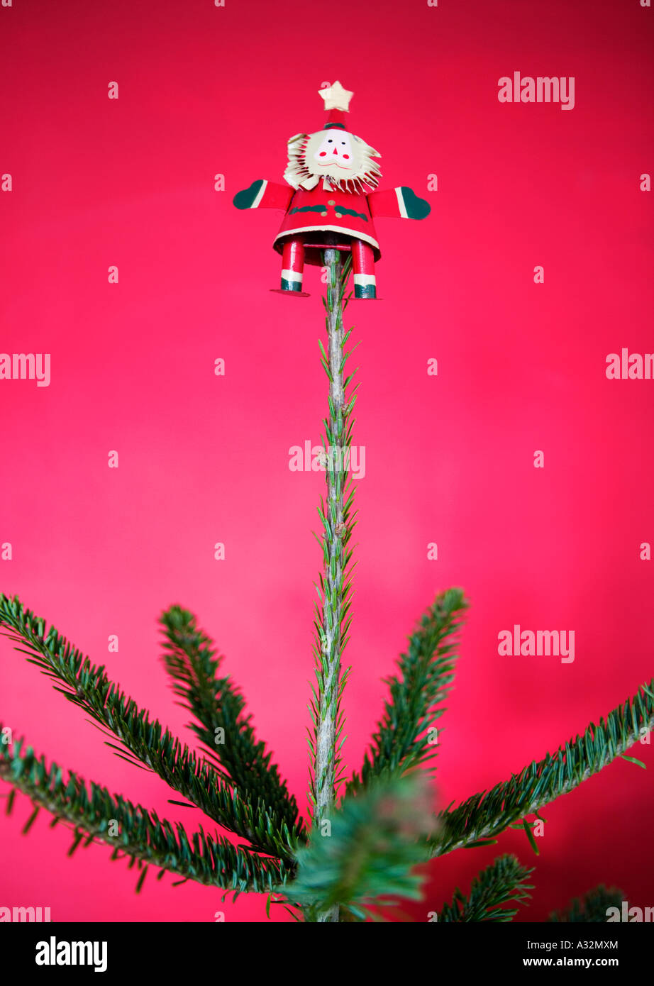 Santa on top of a christmas tree Stock Photo - Alamy